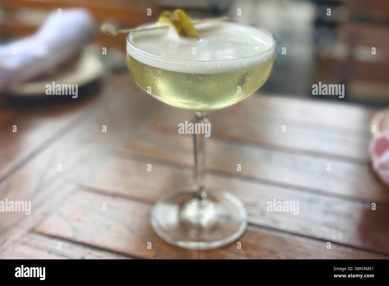 A dirty pickle martini, made with vodka, spicy pickle brine and a ...