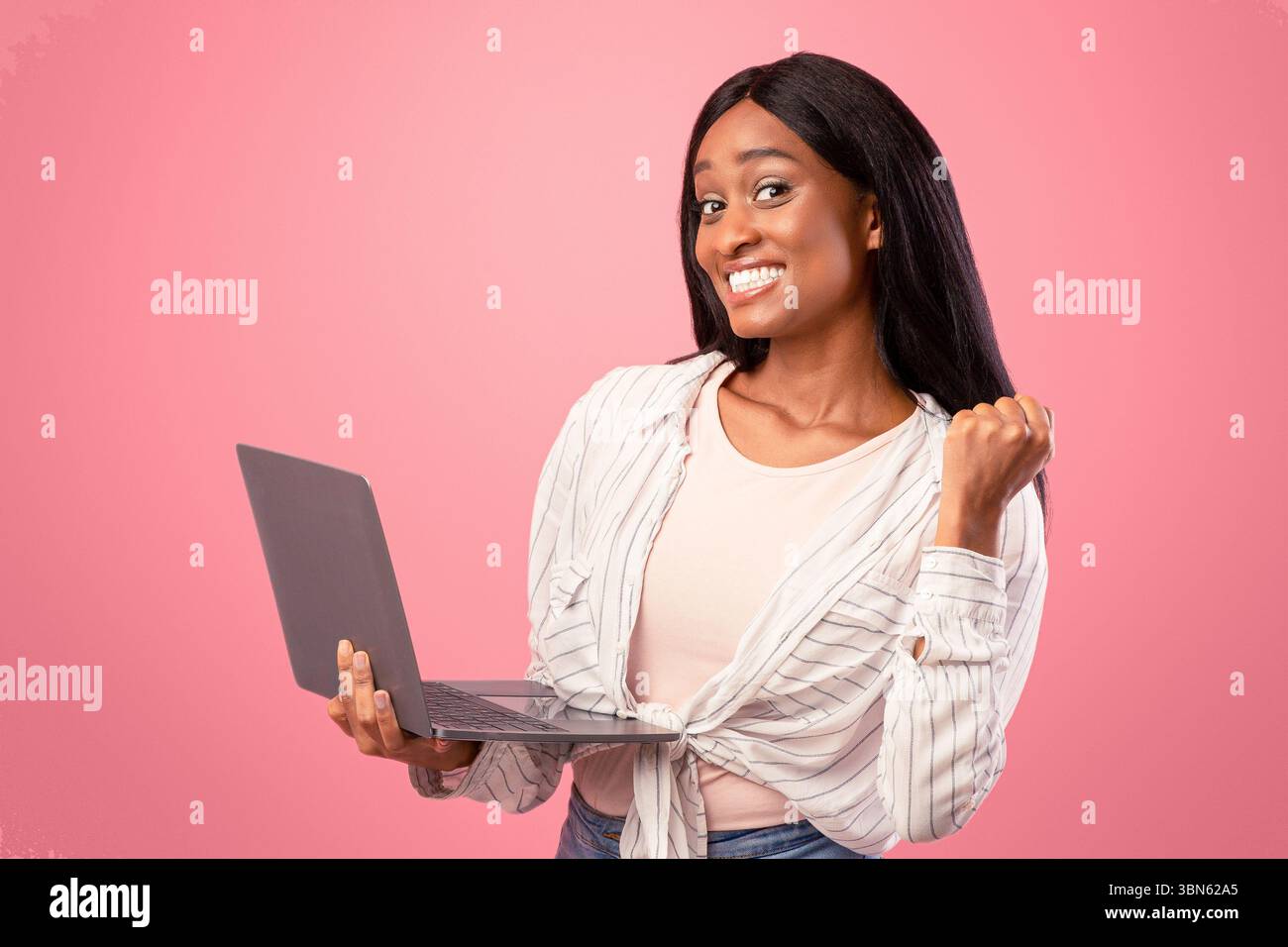 Millennial African American lady with laptop making YES gesture and ...