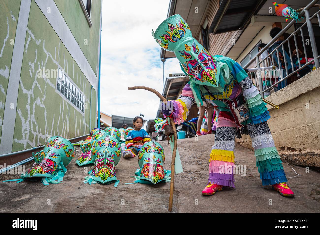 A Chuen baan Phi Ta Khon group participant dressed in a vibrant costume ...