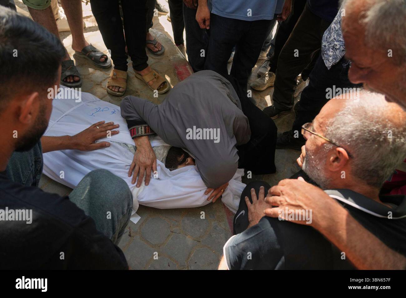 The mother of the Palestinian journalist Ismail Abu Hatab, who was ...