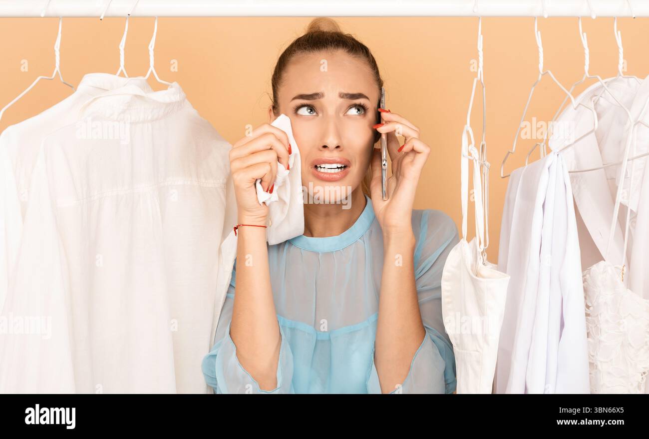 Sad woman crying, having nothing to wear Stock Photo - Alamy