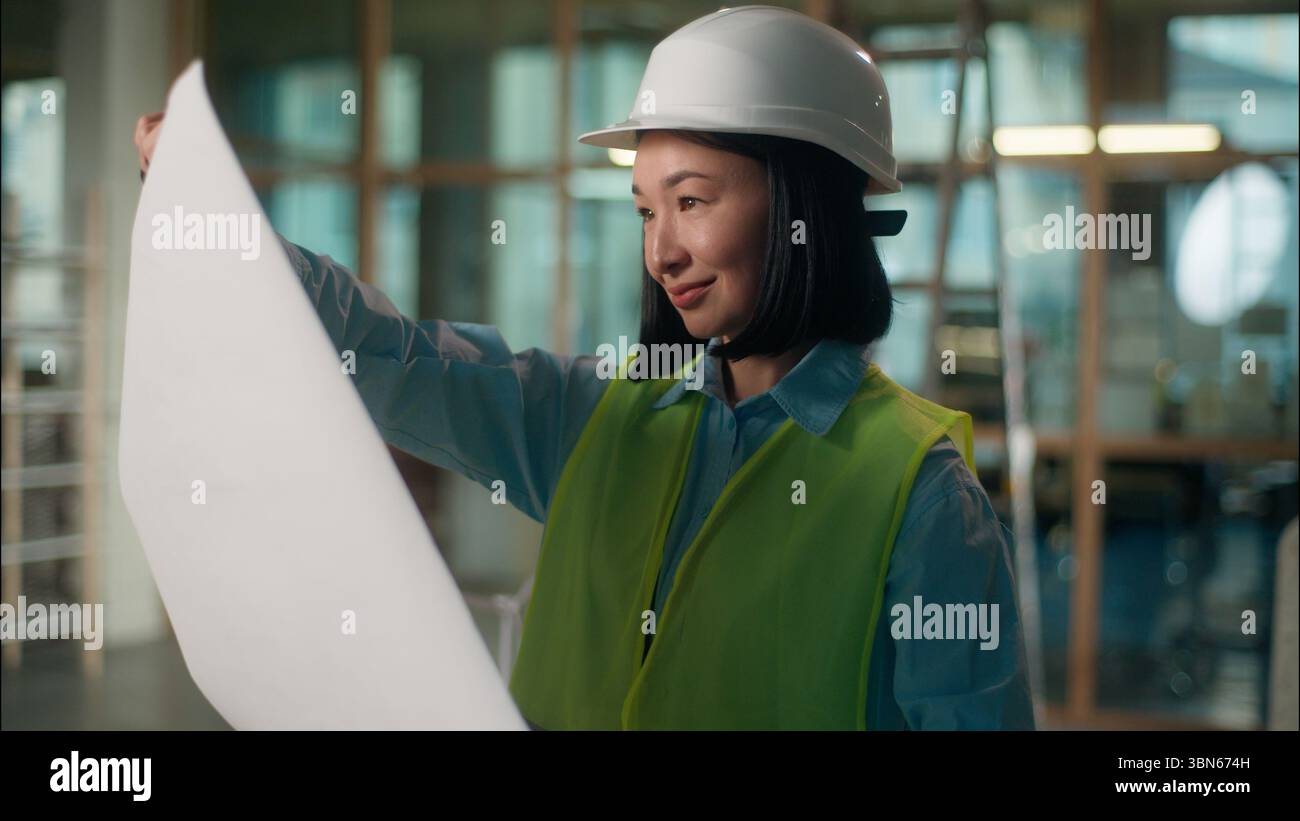Woman civil engineer in hard hat Asian girl inspector looking at ...