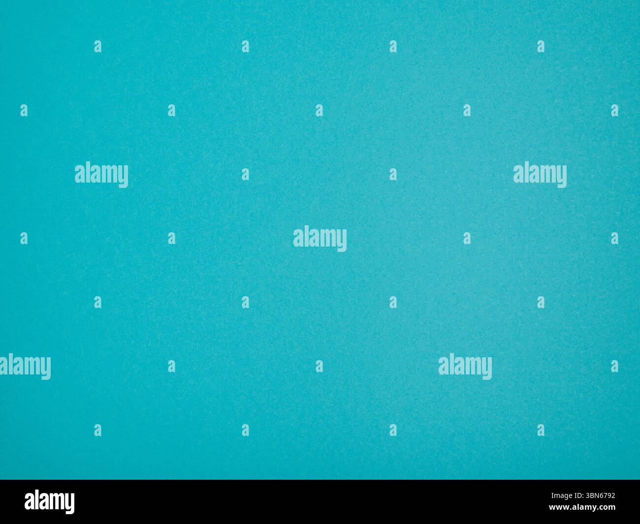 A subtly textured teal surface, exhibiting a smooth and even tone. The ...