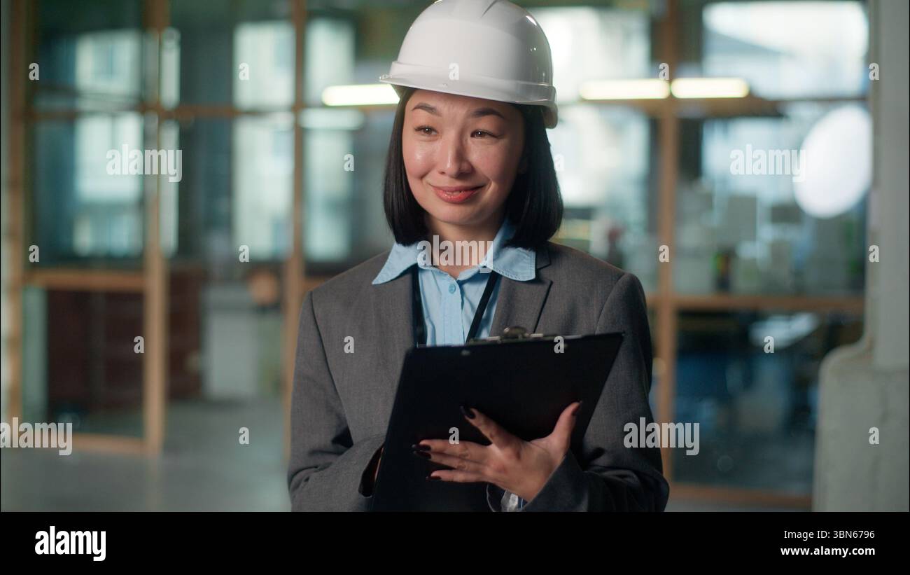 Asian woman builder architect inspector approve construction plan ...