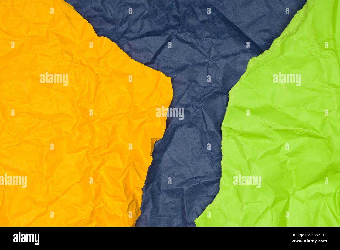 Crumpled paper in yellow, lime green, and navy blue Stock Photo - Alamy