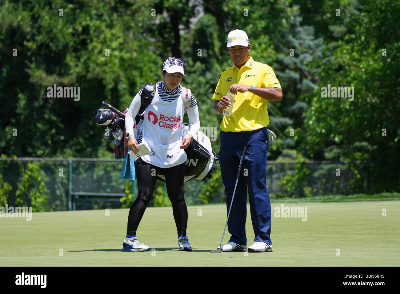 Hideki Matsuyama, of Japan, right looks at a putt with his caddie Mei ...