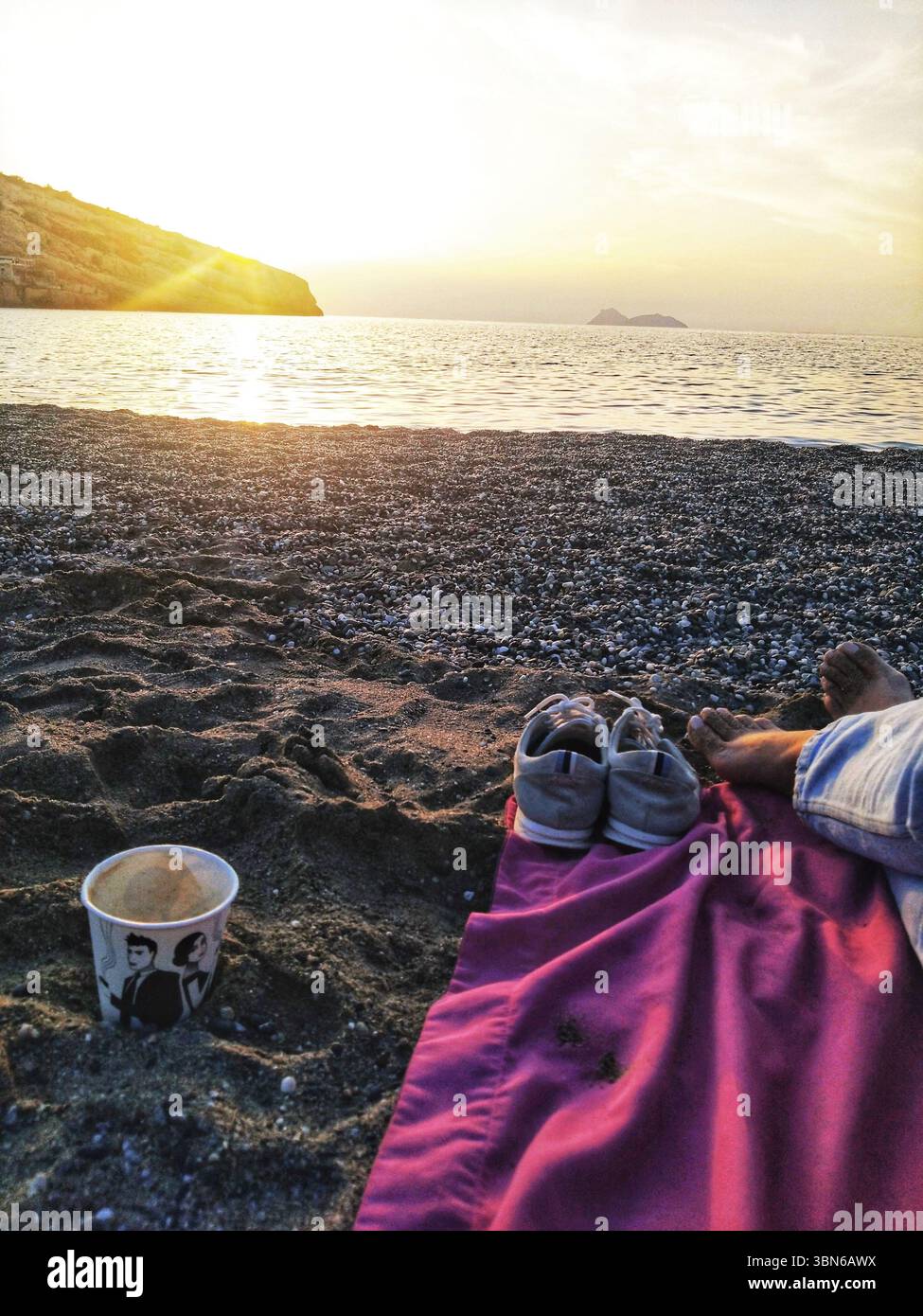 A Young Woman Relaxing at Sunset on the Beach in Matala, Crete Stock ...