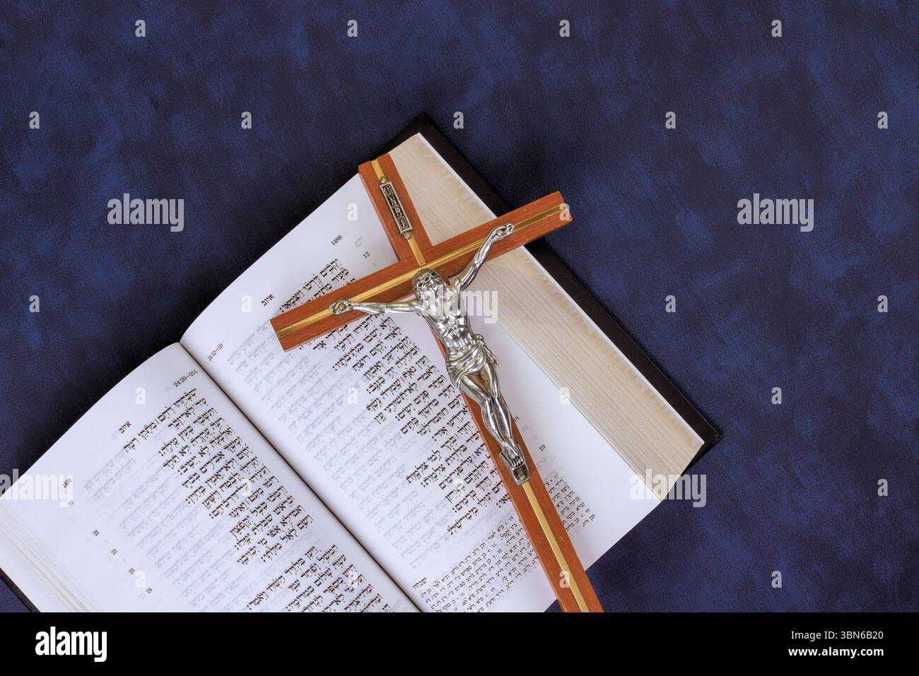 24 April 2025 Jerusalem Israel Wooden crucifix atop an open Hebrew Holy ...