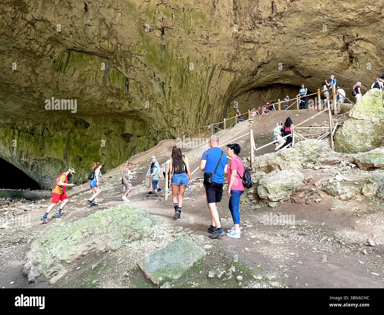 Tourists exploring Devetashka Cave, a natural wonder in Bulgaria’s ...