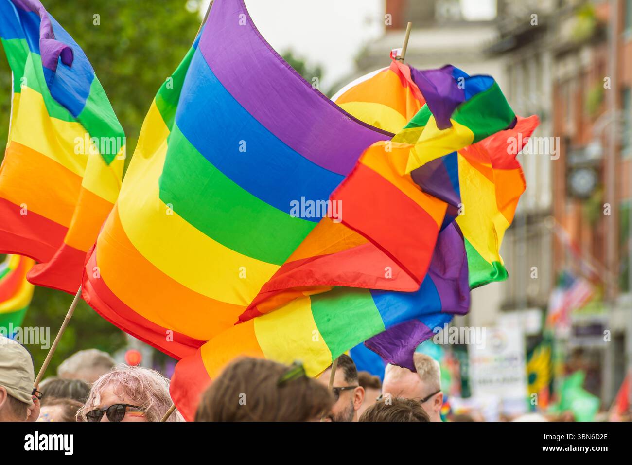 A vibrant rainbow flag waves at Dublin Pride, symbolizing a decade of ...