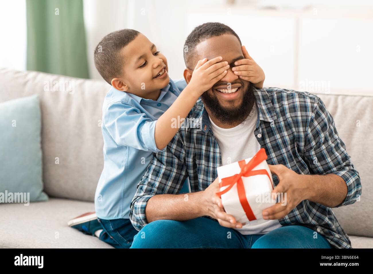 Little Son Congratulating Black Father Giving Wrapped Gift Indoors ...