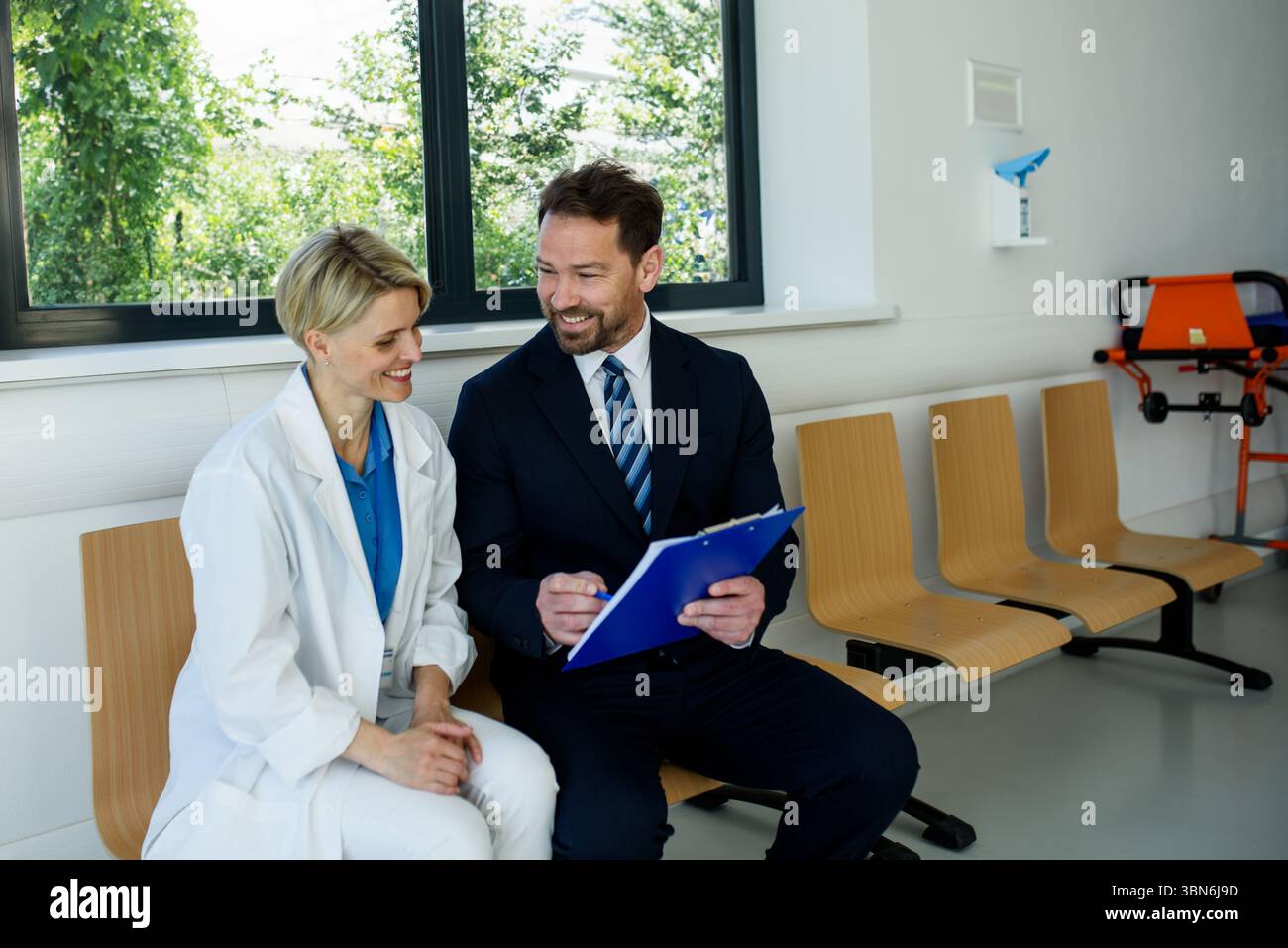 Doctor and pharmaceutical representative talking about new drug ...