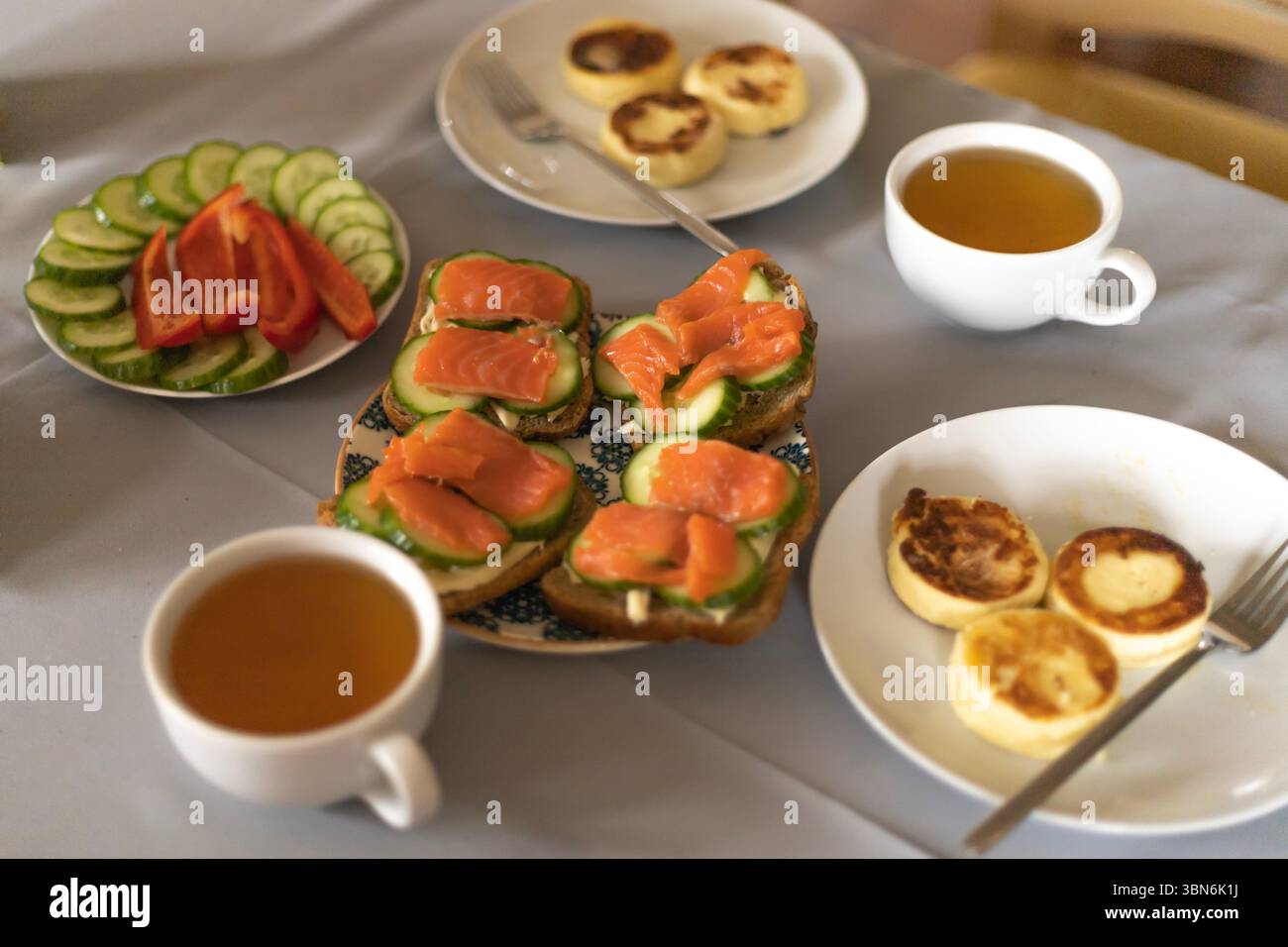 breakfast on the table toast with salted fish and cucumber and ...
