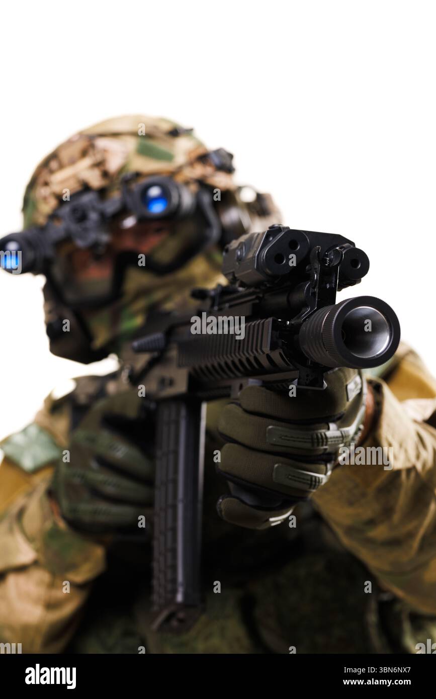 A soldier dressed in advanced combat gear holding a rifle, prepared for ...