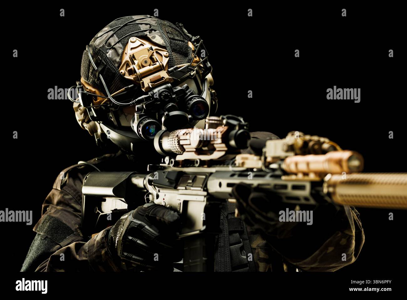 A soldier equipped with high-tech tactical gear and a rifle cautiously ...