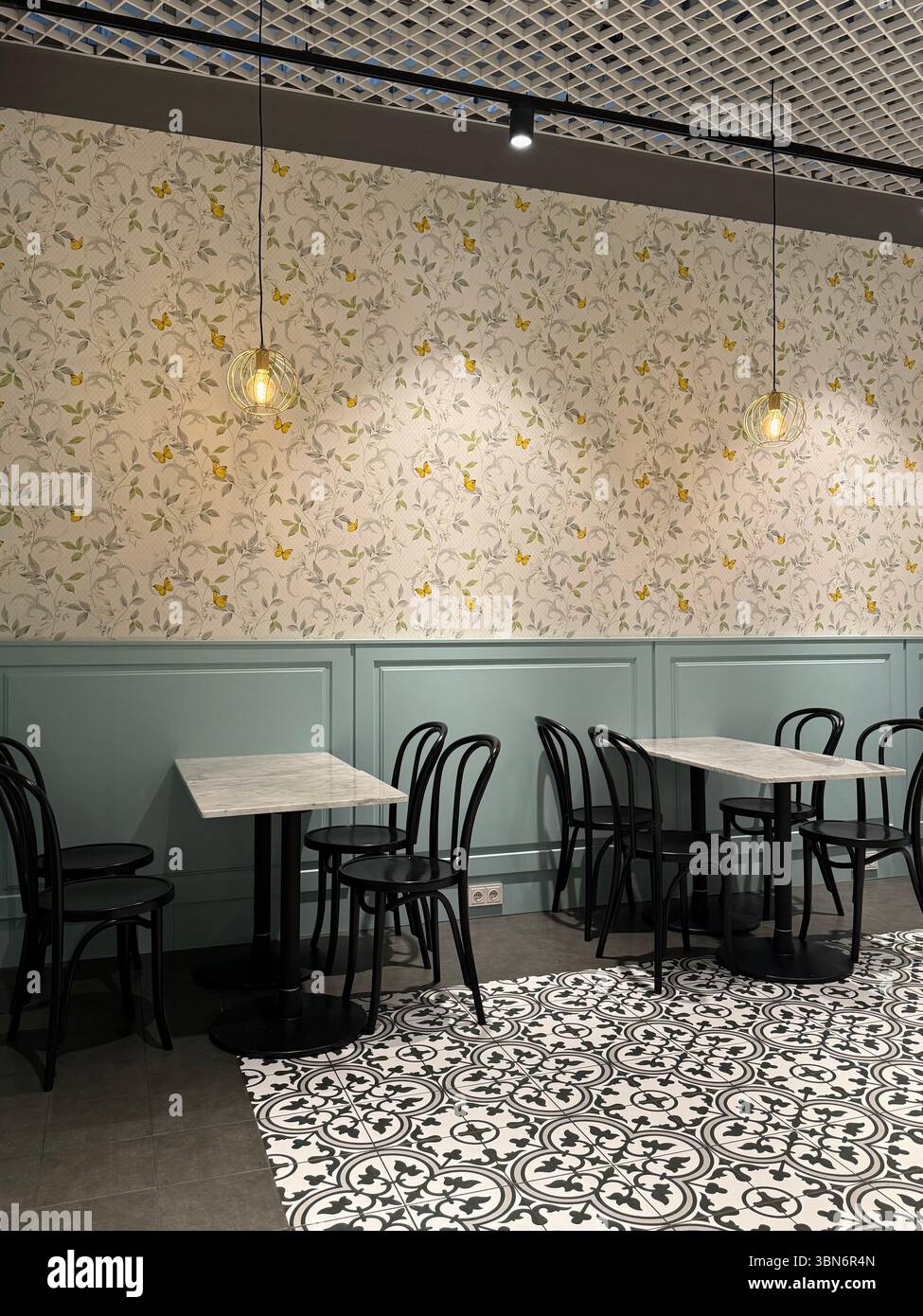 The photo shows a section of a caf interior with multiple seating areas ...