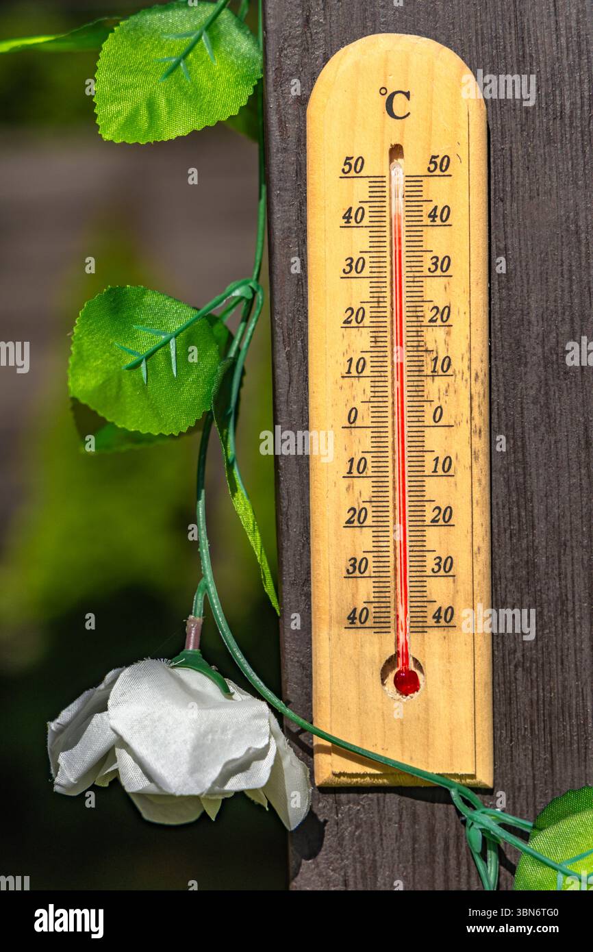 Wooden mercury thermometer showing very high temperature in summer on ...