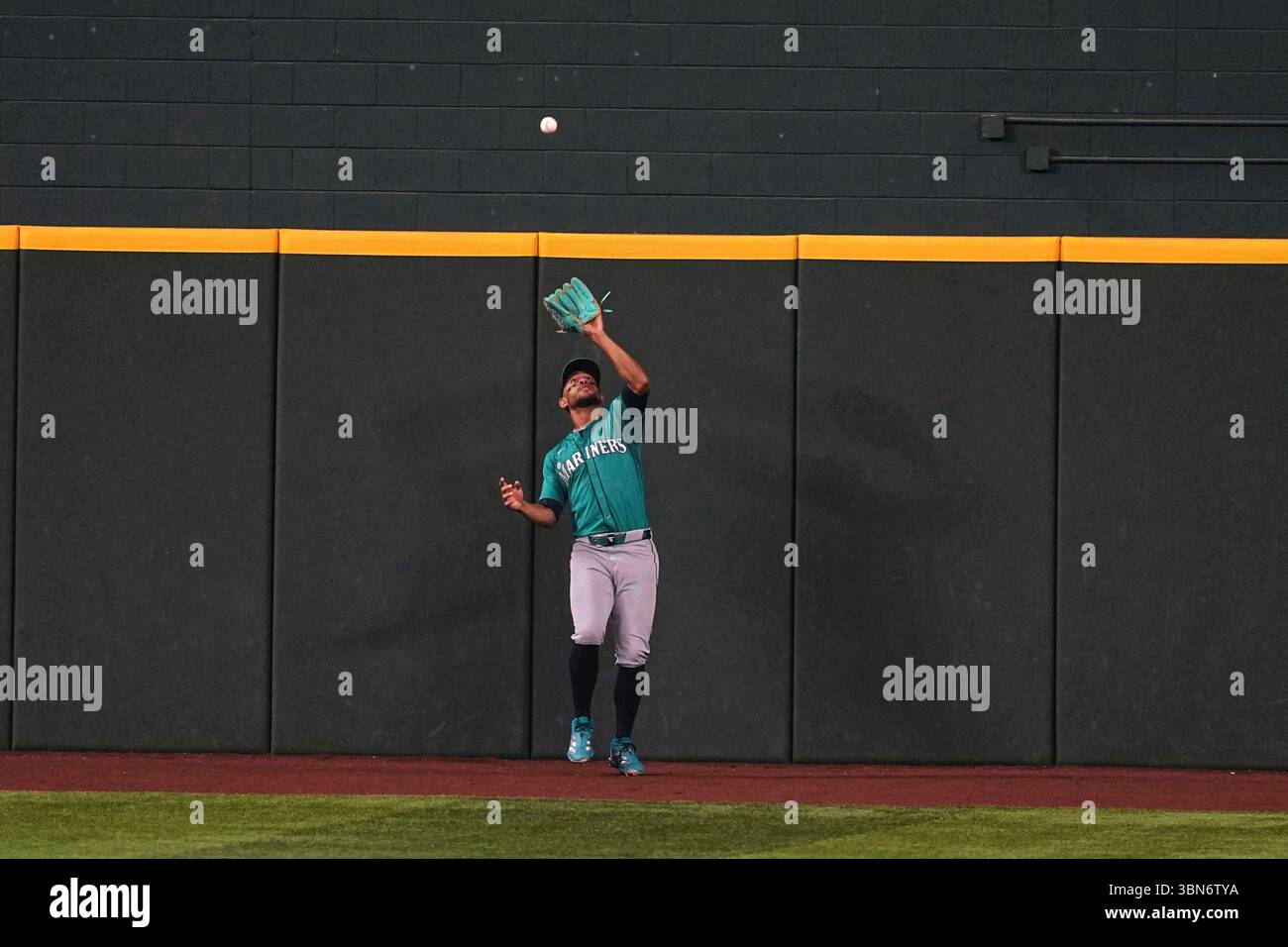 Seattle Mariners center fielder Julio Rodriguez reachesup to catch a ...
