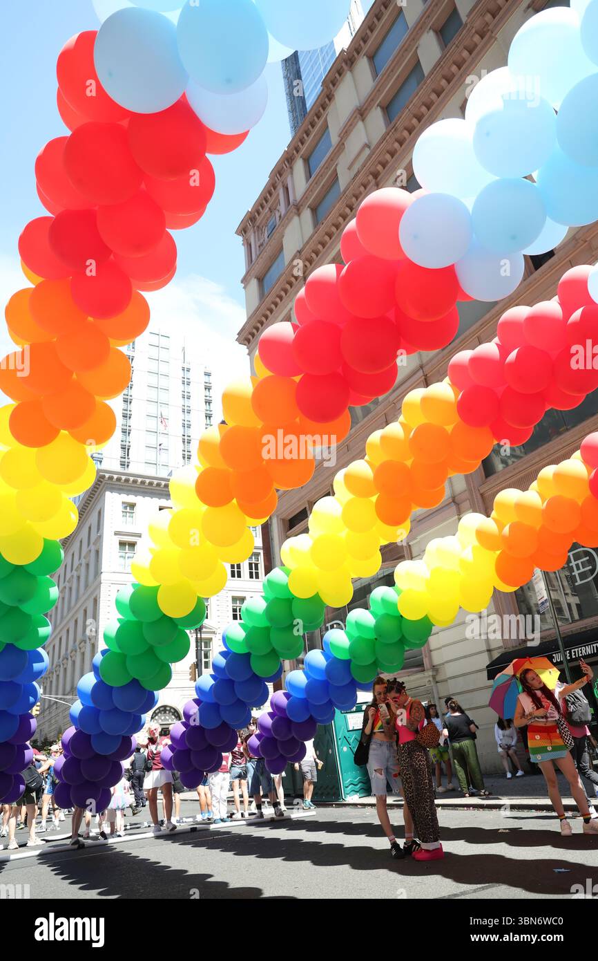 The Heritage of Pride stretches rainbow colored balloons across the ...