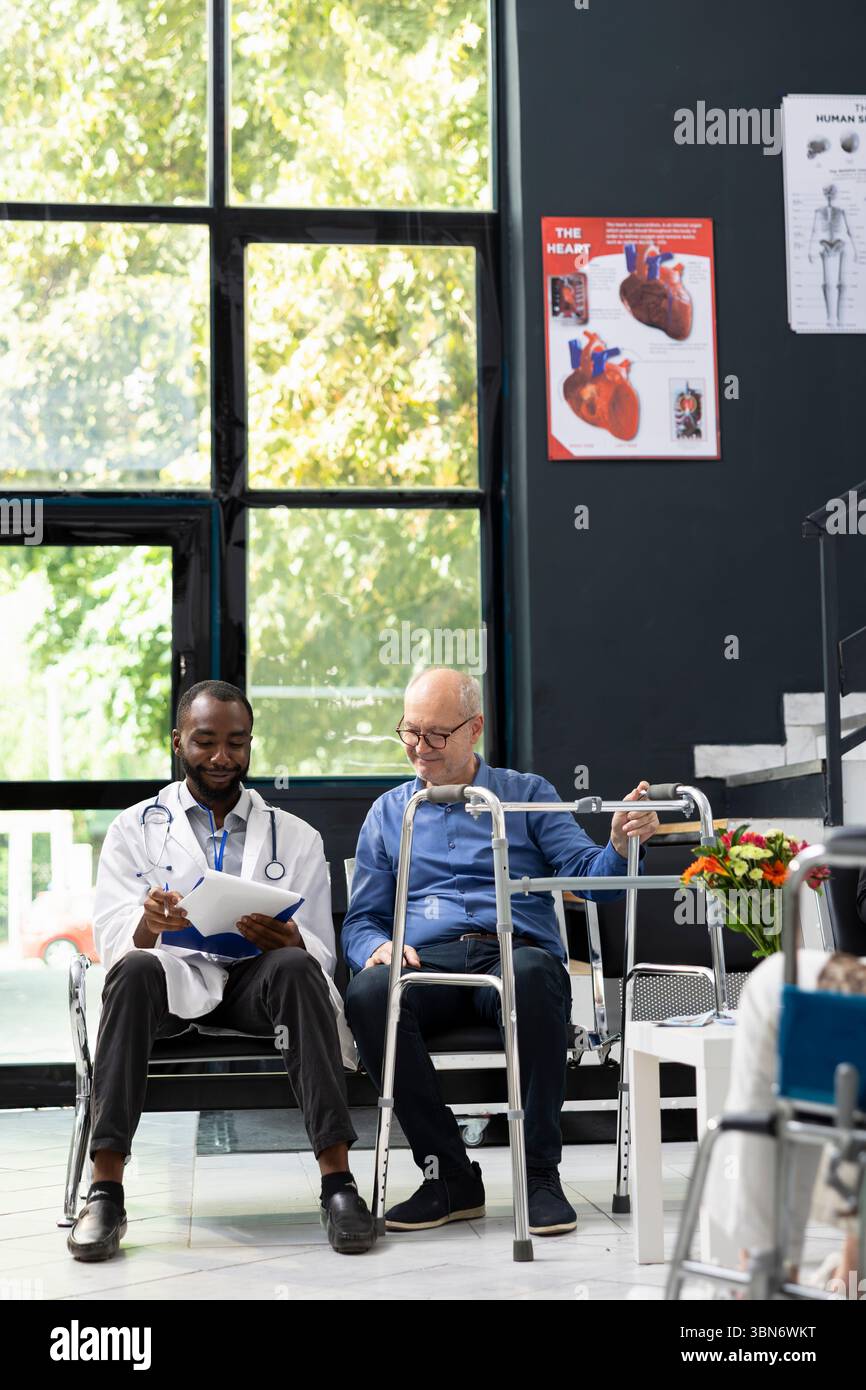 Black medic doing x ray scan interpretation with elderly man in the ...