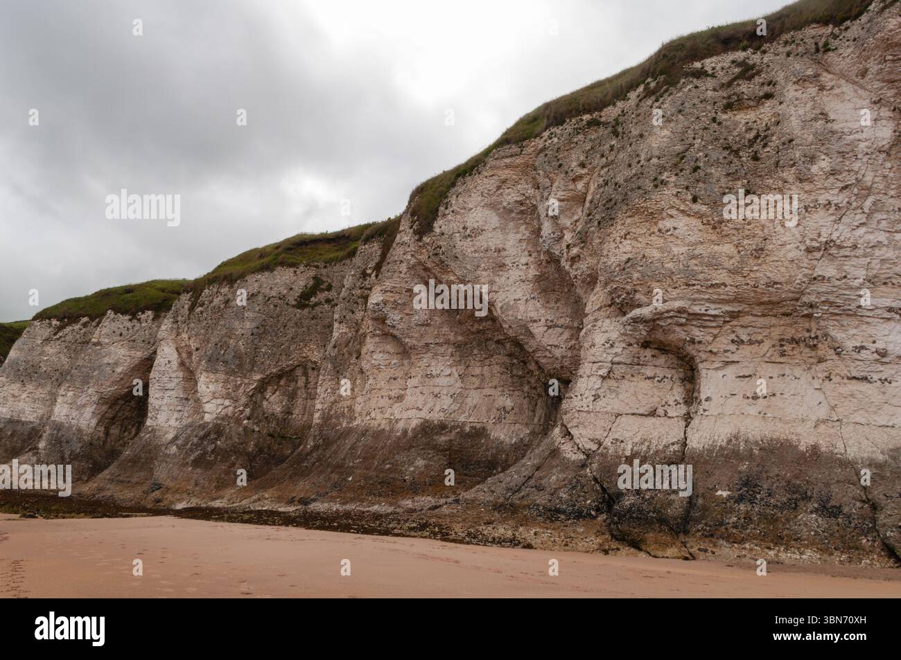 A rocky cliff with a white and gray color. The cliff is very tall and ...