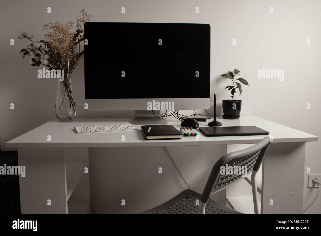 Minimalist home office workspace with a desktop computer, keyboard ...