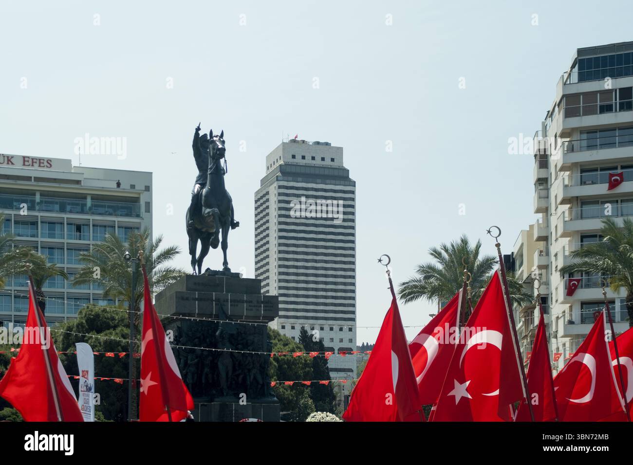 Mustafa Kemal Ataturk statue on square with waving Turkish flags in ...