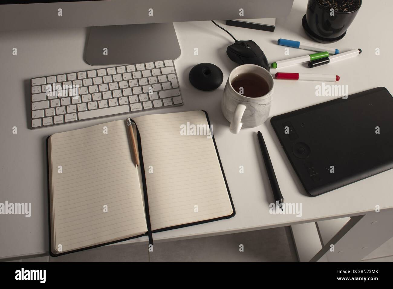 Minimalist home office workspace with a desktop computer, keyboard ...