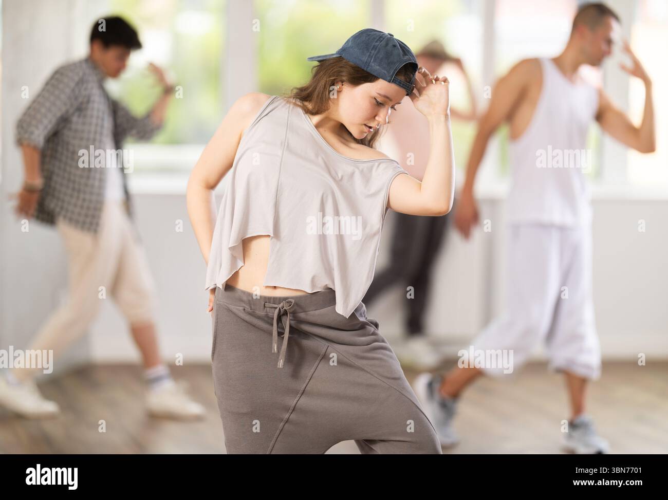 Young girl practicing hip hop slide moves in training hall Stock Photo ...