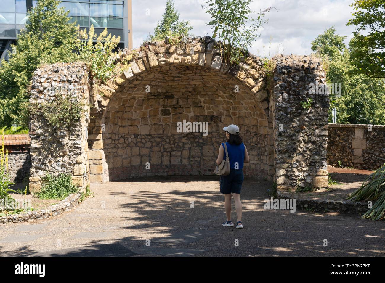 A woman visitor looking at the historic Reading Abbey ruins in the ...