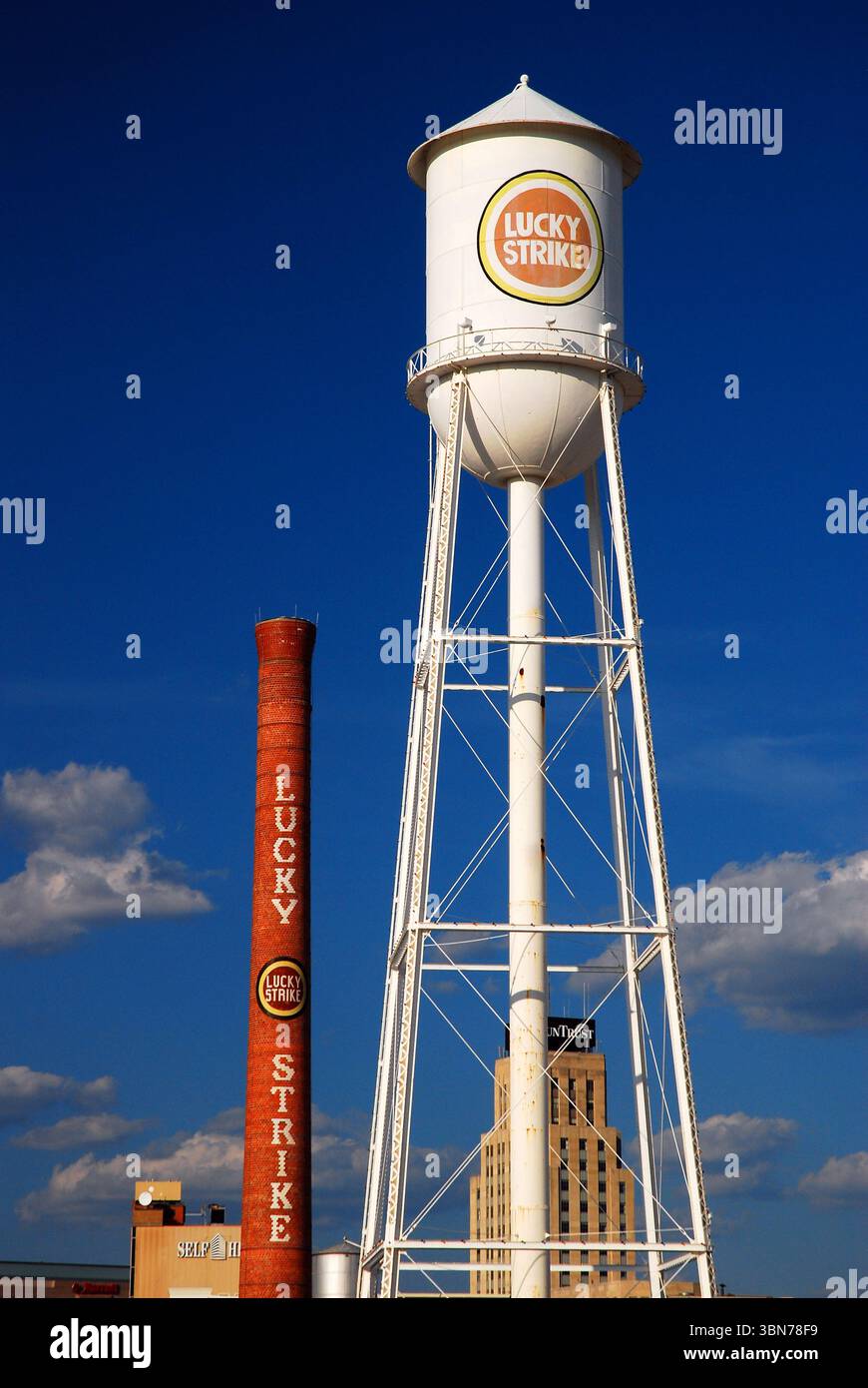 A large water tower displaying the logo of a cigarette company, a ...