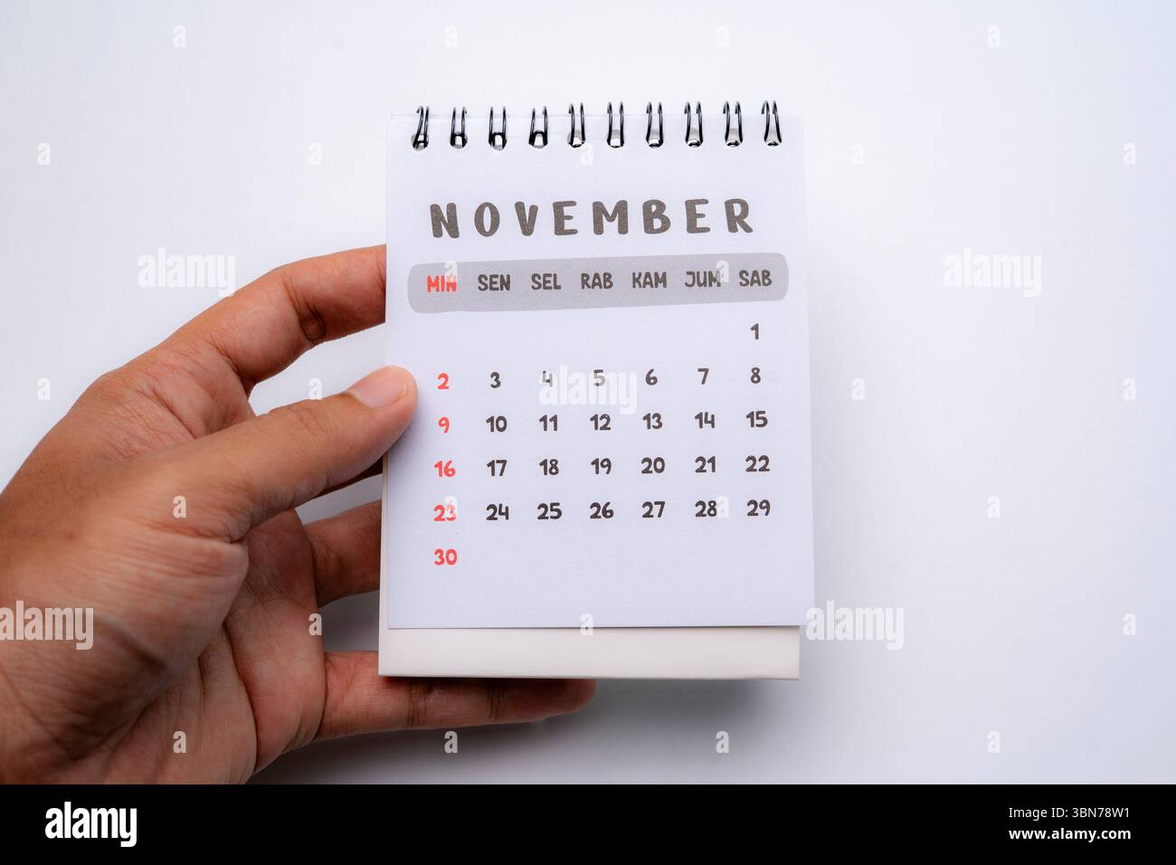 hand holding desk calendar showing november month Stock Photo - Alamy