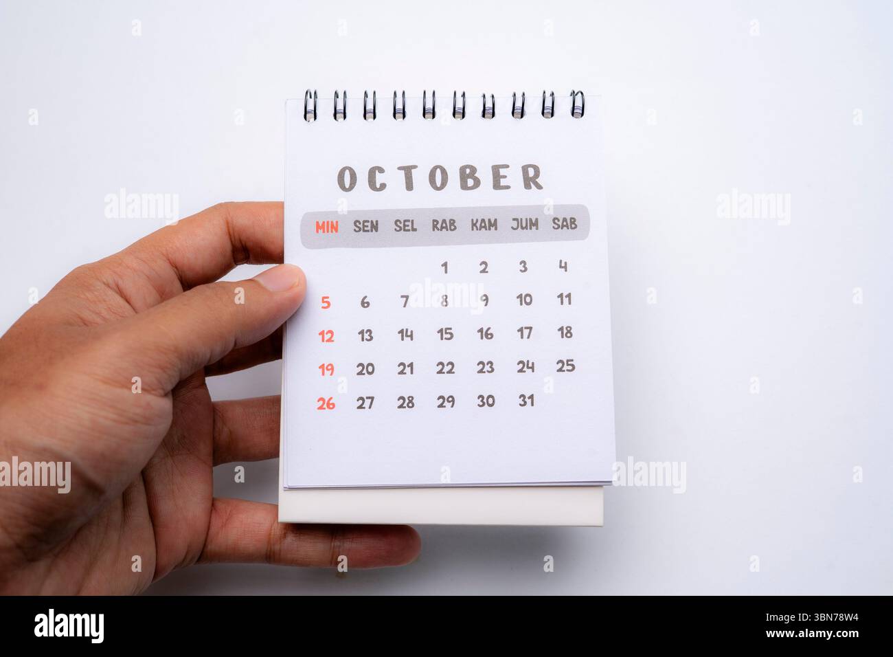 hand holding desk calendar showing october month Stock Photo - Alamy