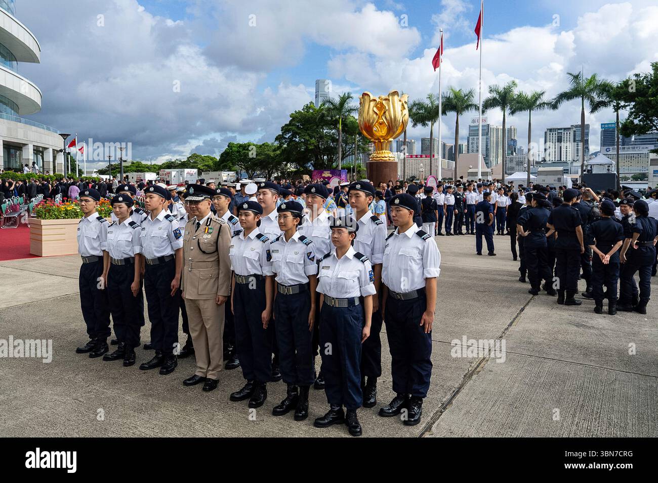 Volunteers take photographs at a flag raising ceremony to mark the 28th ...