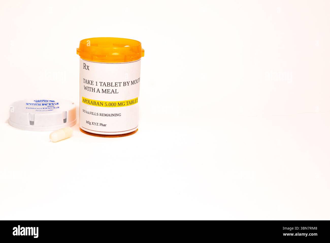 A container of prescription APIXABAN with one capsule in front of it ...