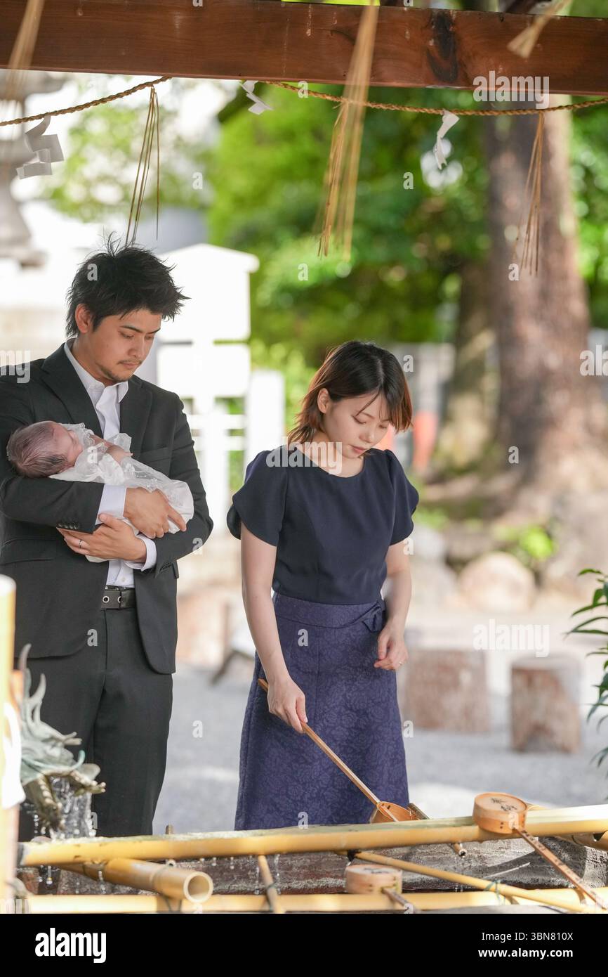 In June 2025, a young Japanese couple in their early twenties purifies their hands at the ...