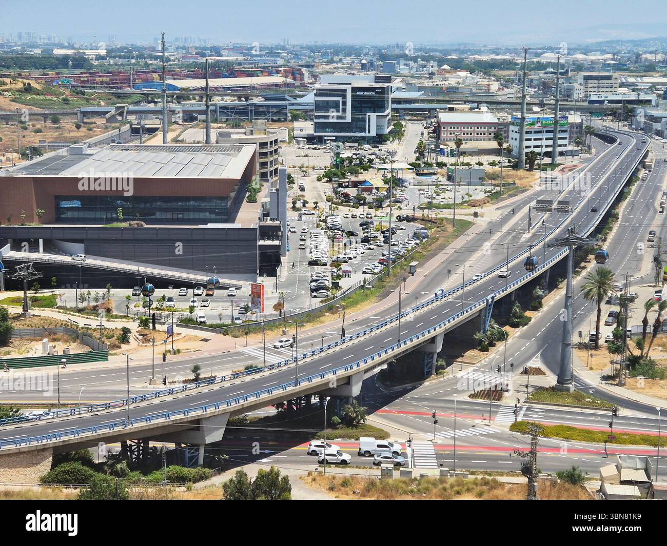 A zoomed aerial view of an industrial urban area, revealing traffic ...