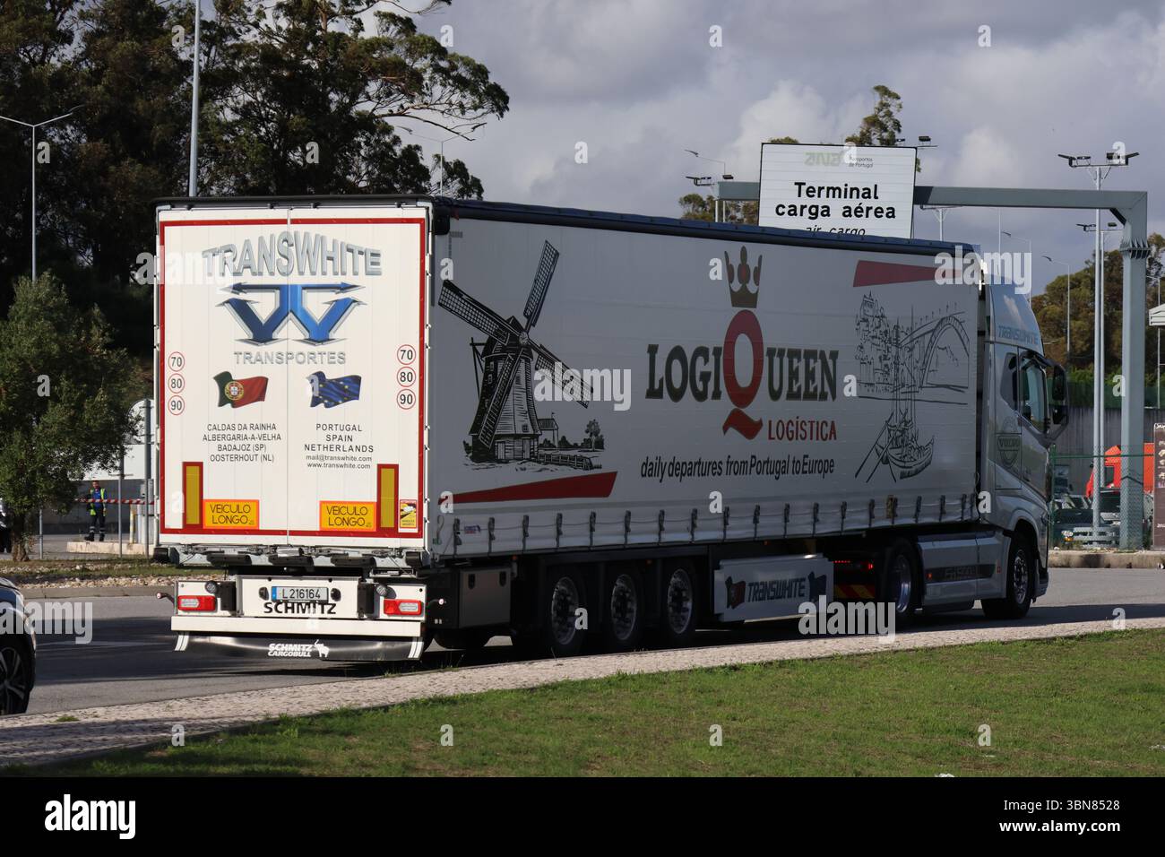 White scania truck driving near air cargo terminal, transporting goods ...