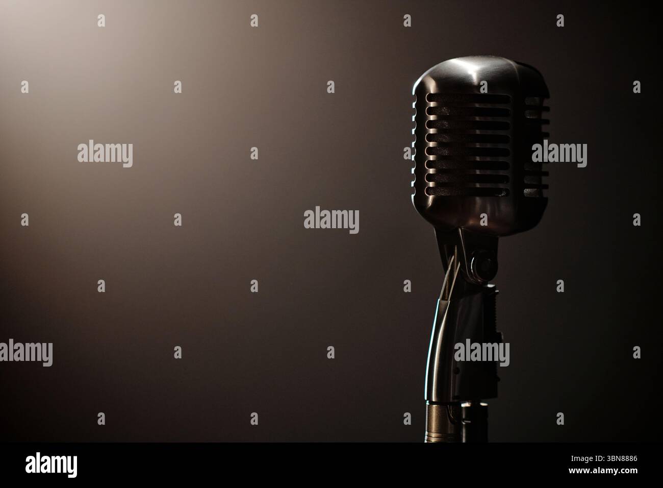 Vintage microphone standing on stage with dramatic lighting, classic ...