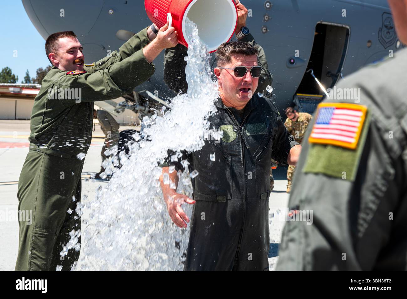 U.S. Airmen, friends and family spray water on Col. Steven Byrum, 60th ...