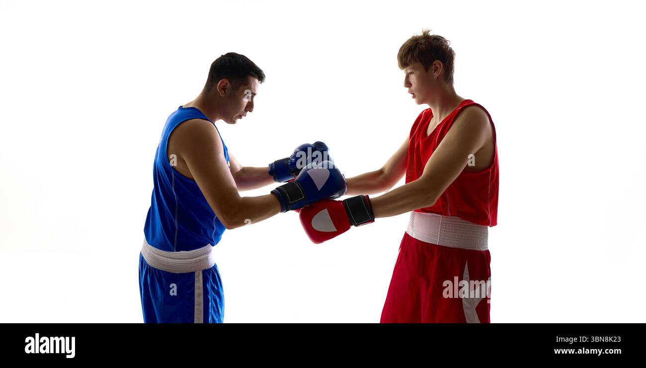 Two boxers in red and blue gear showing sportsmanship with handshake ...