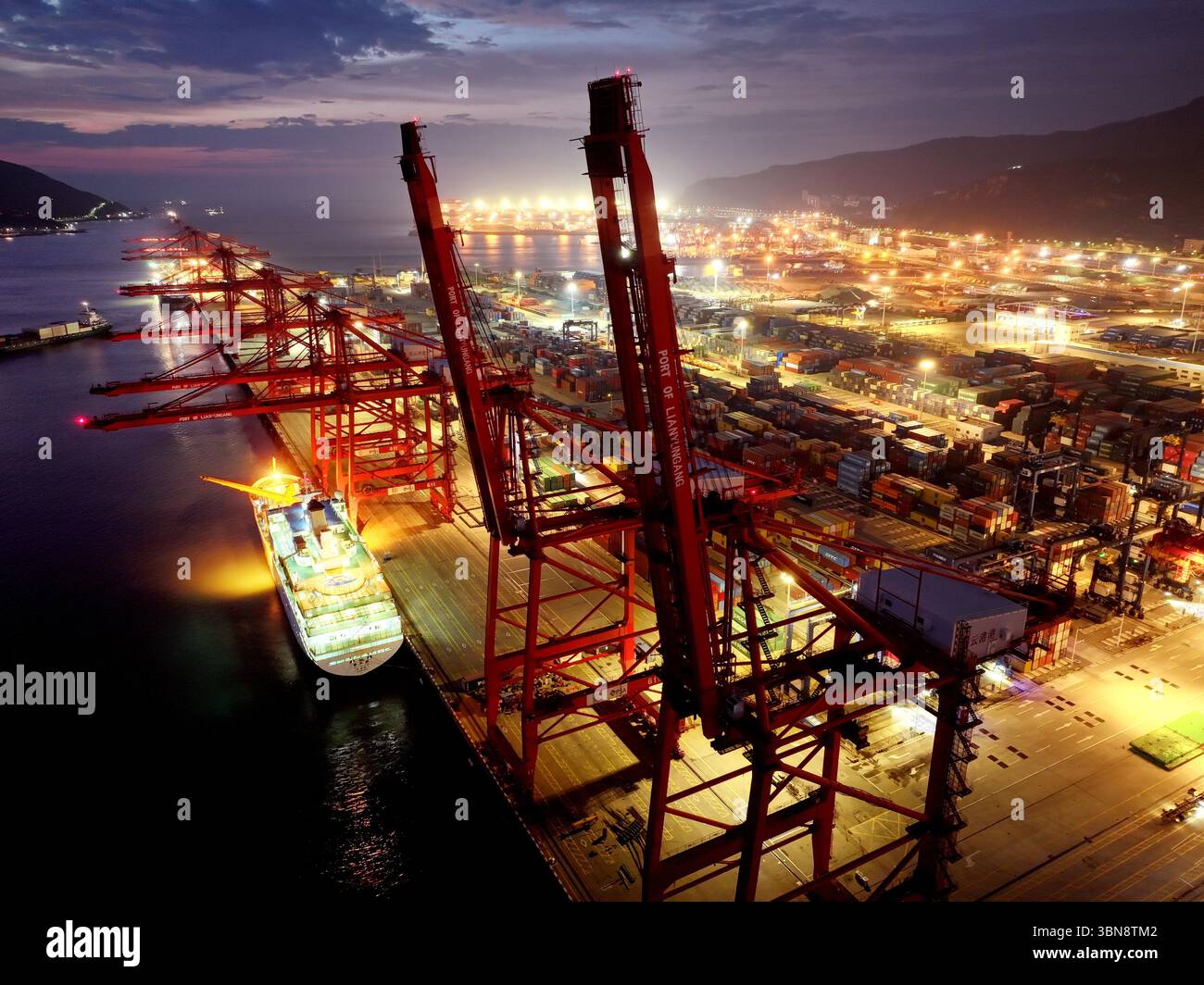 Aerial photo shows the container terminal of Lianyungang Port at night ...