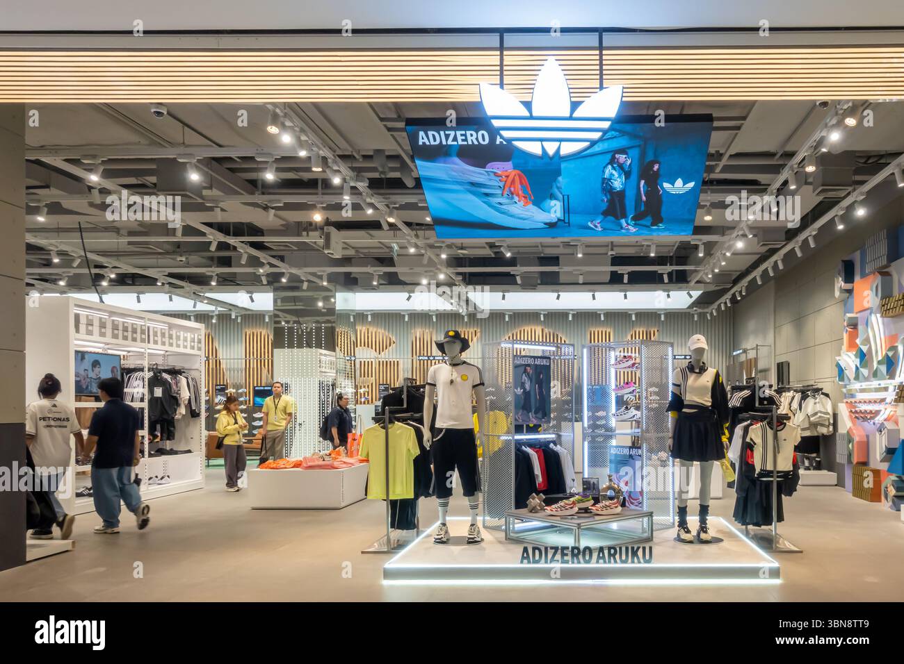 interior of an Adidas store with clothes and shoes on display. Adizero ...