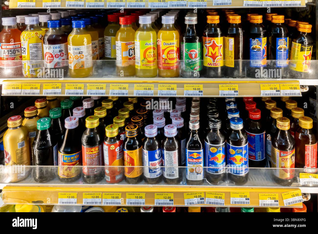 Energy drinks on shelf in 7-11 store in Bangkok, Thailand. Rows of ...