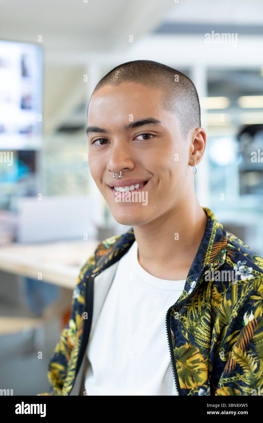 Man wearing botanical print jacket working at office desk with desktop ...