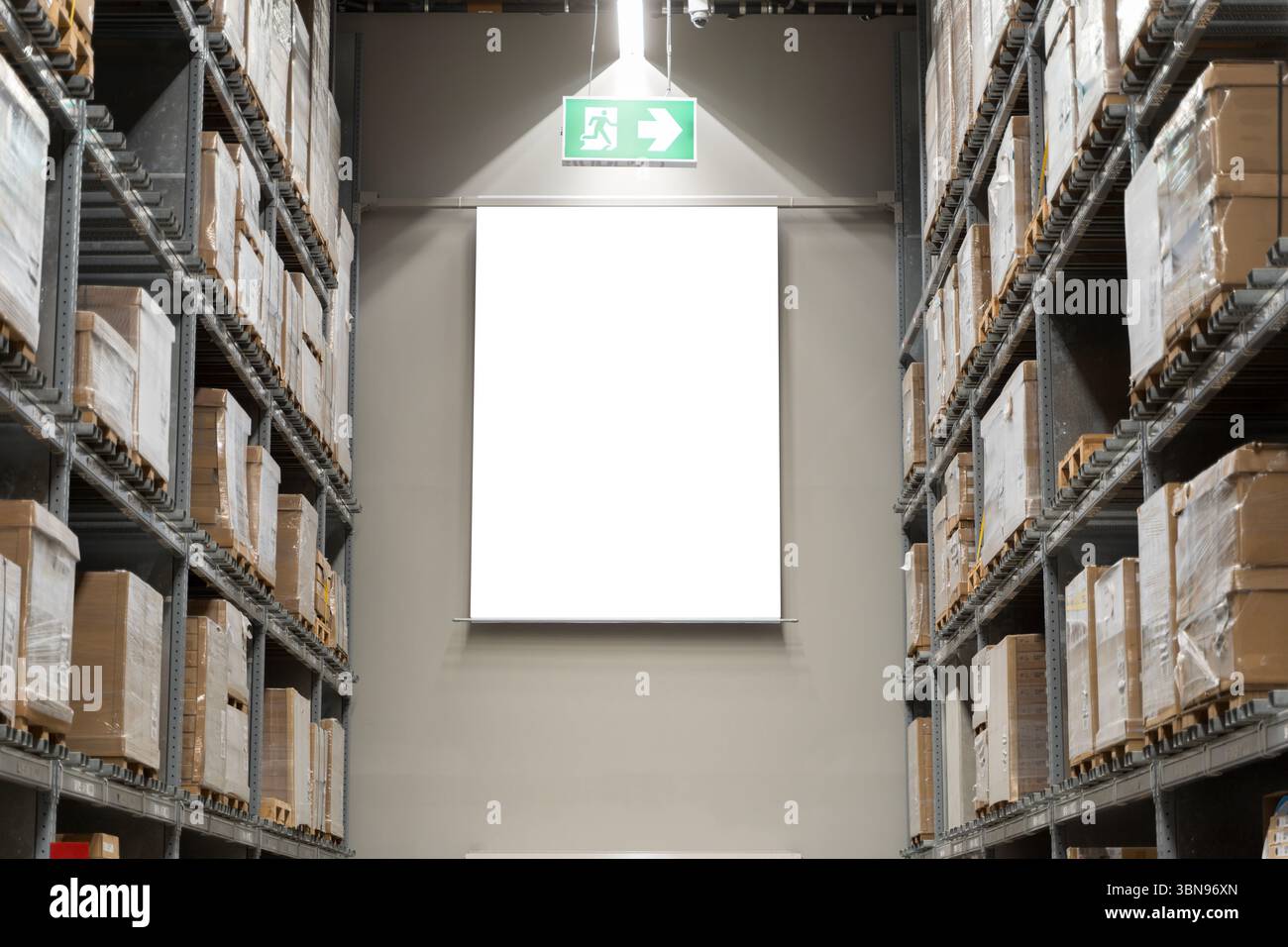 Interior of warehouse aisle with tall metal racks filled with packed ...