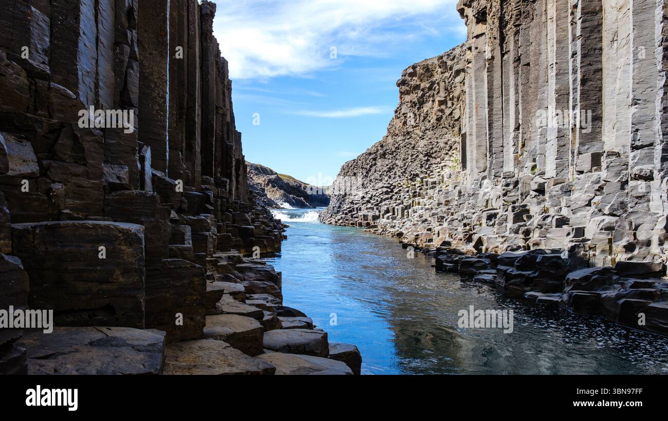 Majestic basalt columns frame the serene waters of Studlagil Canyon in ...