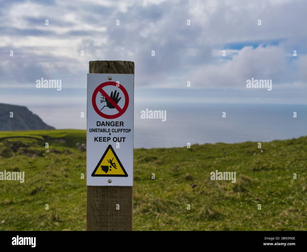 Shetland, UK - Jun 08 2025: A warning sign for an unstable cliff edge ...