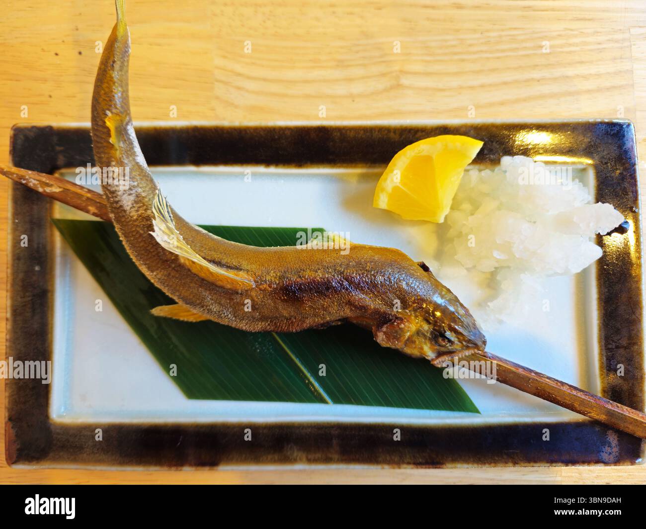 Japanese Grilled Ayu Sweetfish with Daikon and Lemon Stock Photo - Alamy