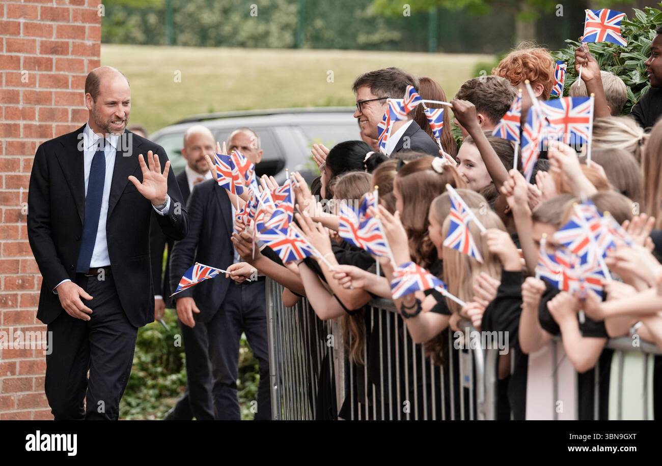 The Prince of Wales meets pupils during a visit to Meadowhead Secondary ...